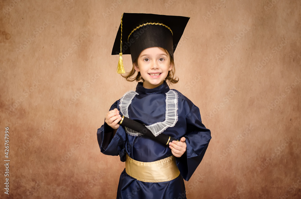 Beautiful little girl happy with her graduation. Dressed with her ...