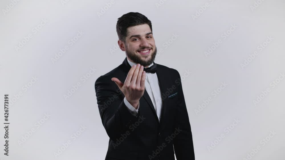 Handsome man in tuxedo showing - Hey you, come here. Showman guy ask ...