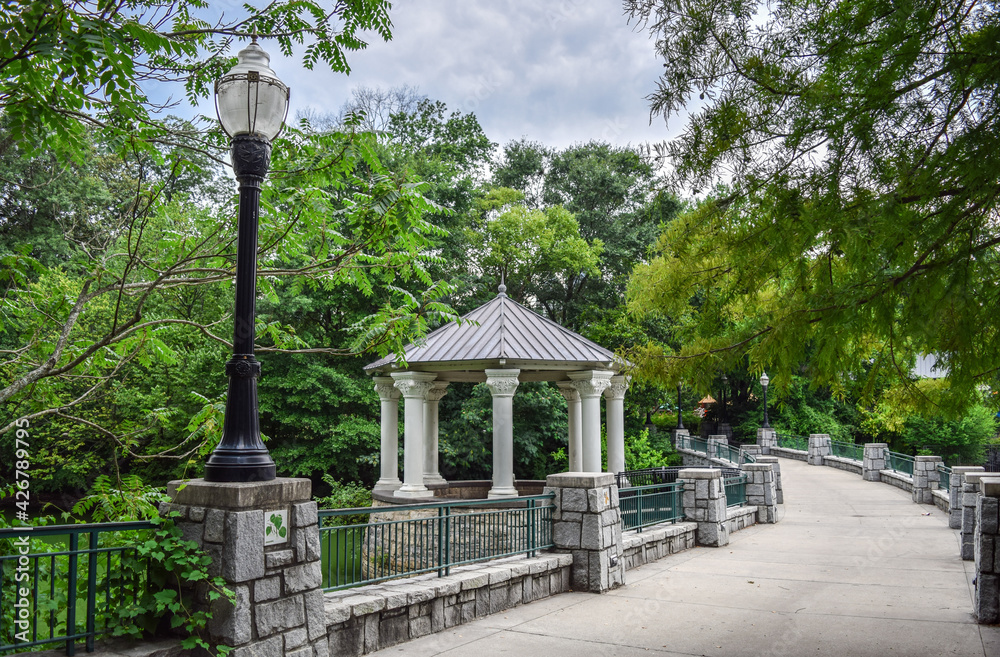 Wide Pedestrian Walkway on top of Concrete Bridge above Pond and ...