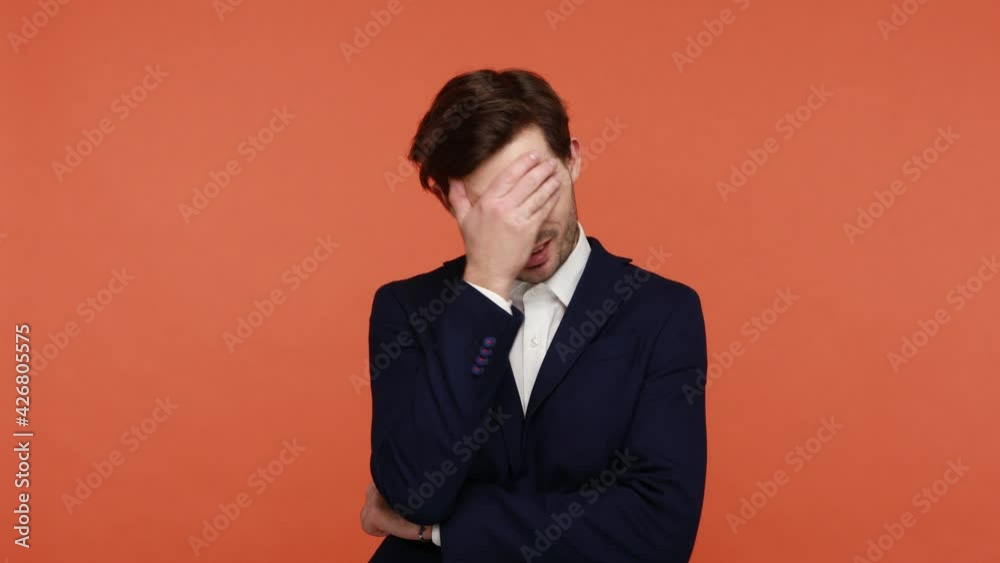 Unhappy bearded man slapping hand on forehead, doing facepalm gesture ...