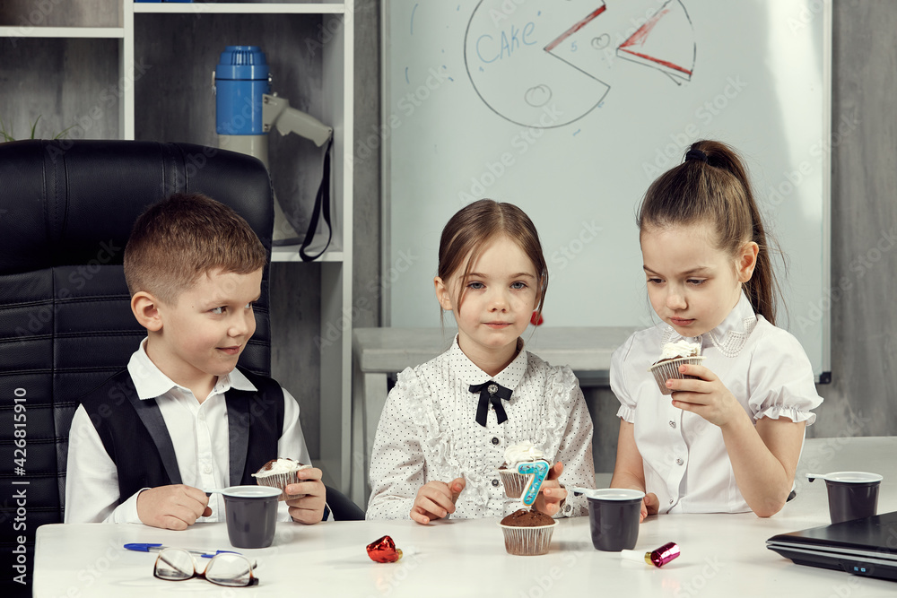 Foto de Children dressed as office workers celebrate the company's ...