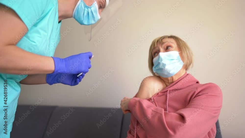 Safe immunization for old people concept. Doctor giving flu shot to ...