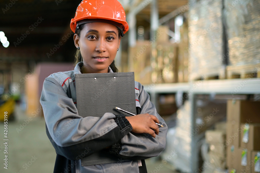 Portrait of a young black woman at work. Worker of production Stock ...