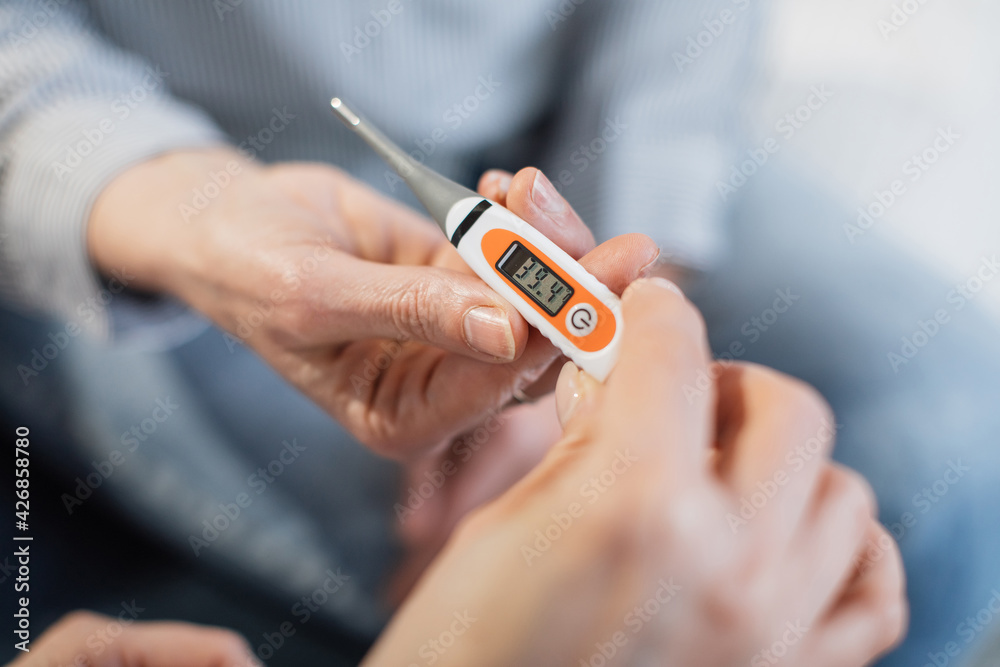 Fever, measuring temperature. Medical examination. Close up shot of ...