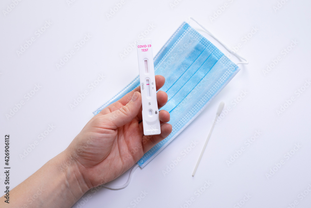 Hand holding rapid Coronavirus test on the white background. Negative ...