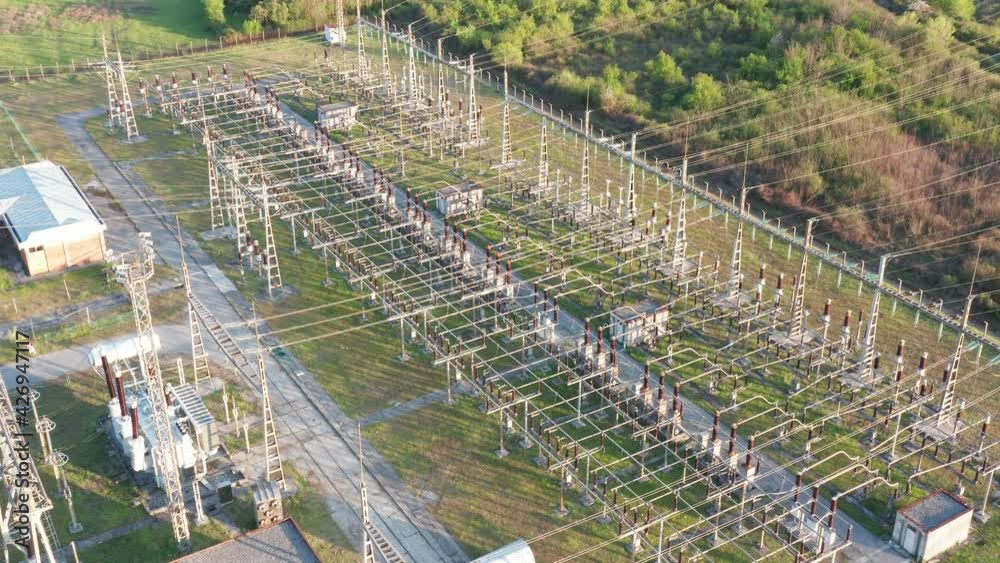 Stockvideon Electrical substation: transformers and grid of pylons ...