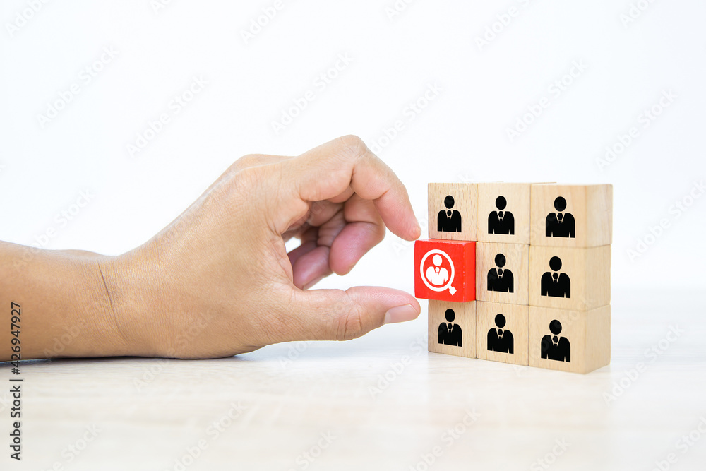 Hand choosing people icon on cube wooden toy block stacked. Concepts of ...