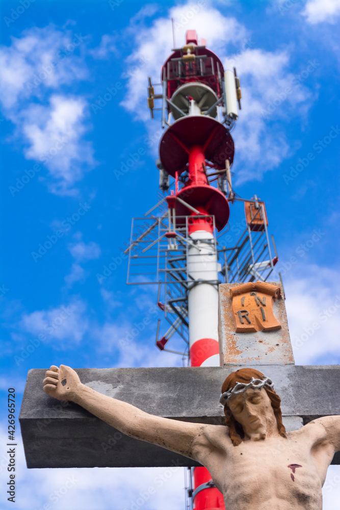 Transmission tower and crucified Jesus Christ in Szekszard Stock Photo ...
