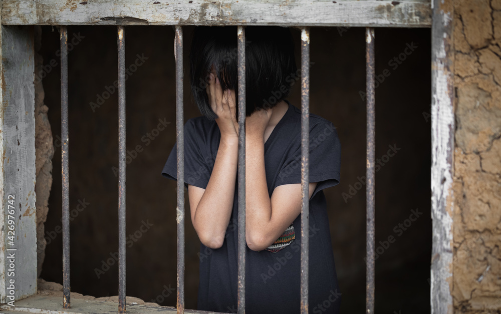 little girl is locked in an iron cage. Restriction of the rights of ...