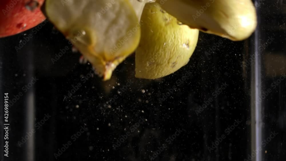 Apple slices splash falling into water isolated on black background ...