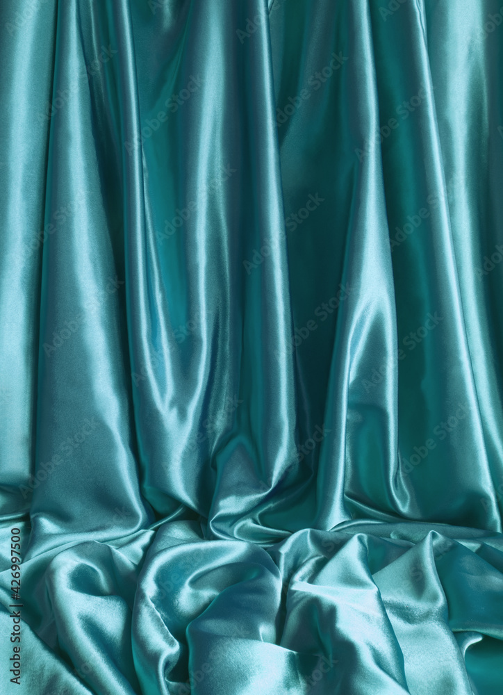 Blue silk fabric drapes. Elegant smooth turquoise satin. Luxurious ...