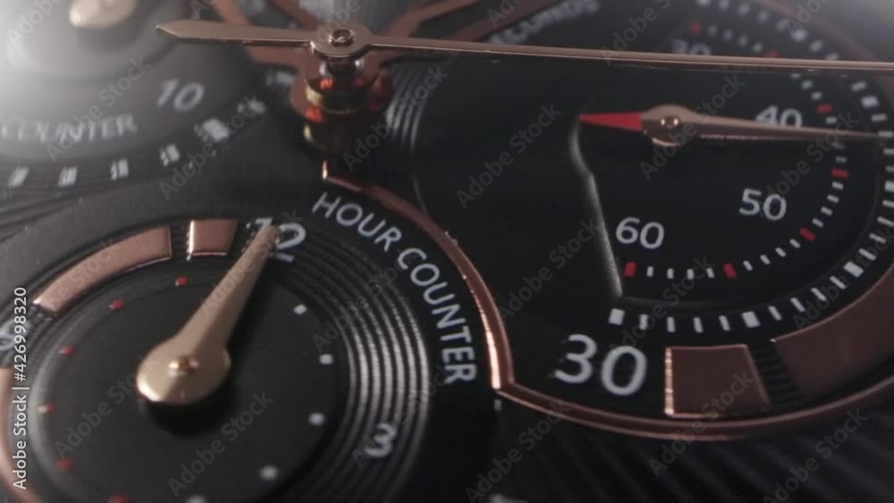 Golden second arrow running on black striped clockface. Rotating swiss ...