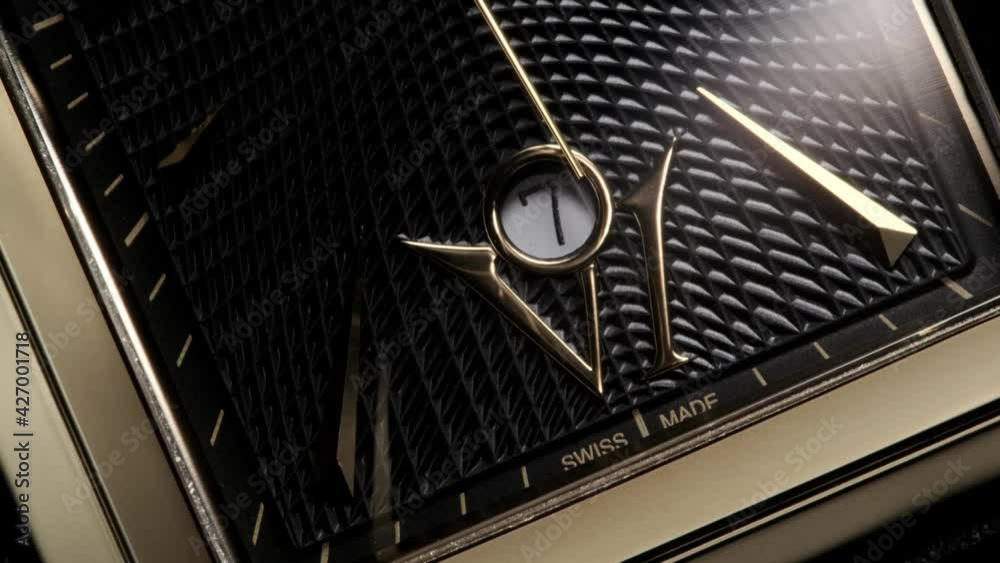 Luxury golden swiss made watch with square body and waffle pattern on ...