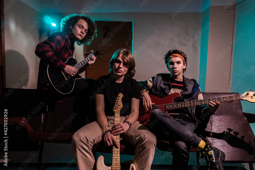 Music and fashion. Group portrait of musicians. Handsome young men ...