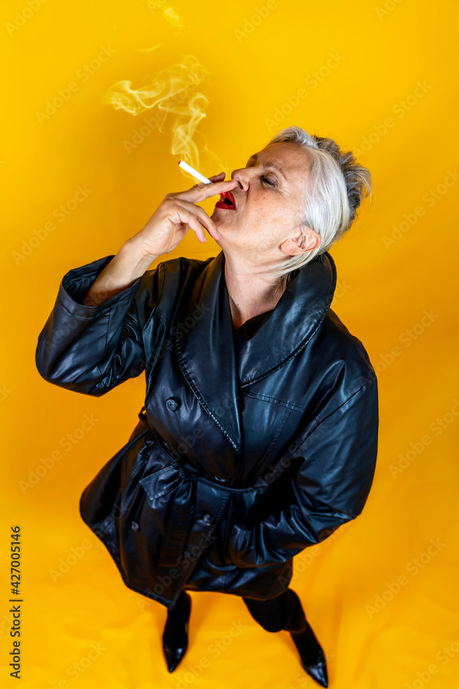 Funny portrait of mature woman. Sophisticated lady having fun dressed ...