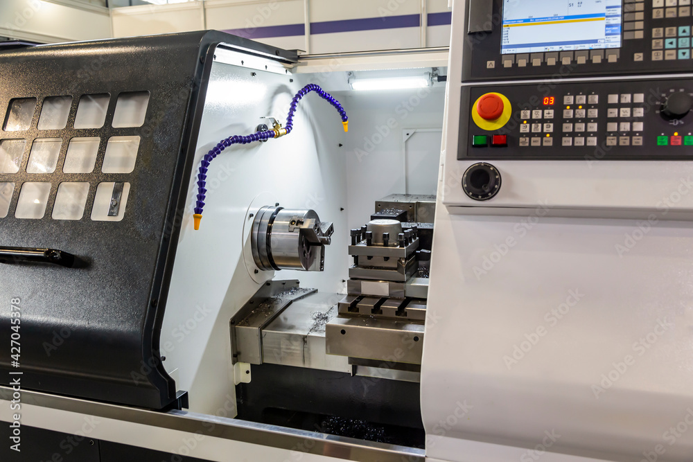 front view of cnc machine, control panel and working area of the lathe ...