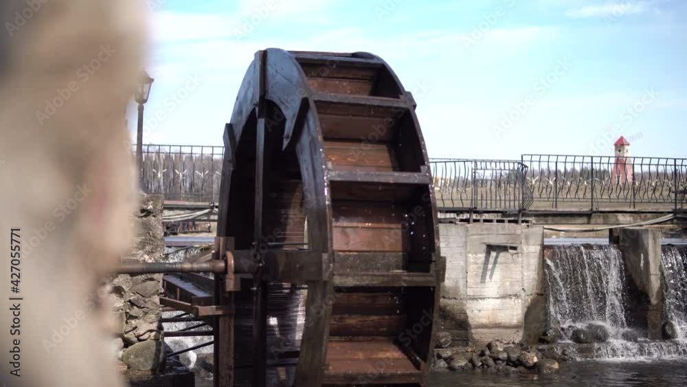 The wheel of an old water mill. A restored mill on the river. Using ...
