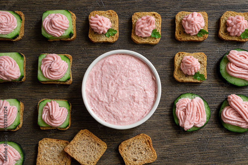 Variety of toasts with tarama and white bowl with taramasalata on a ...