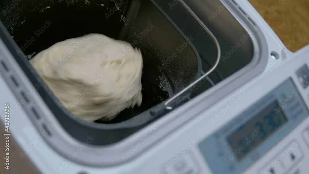 The process of kneading dough in a bread pan in a homemade bread ...