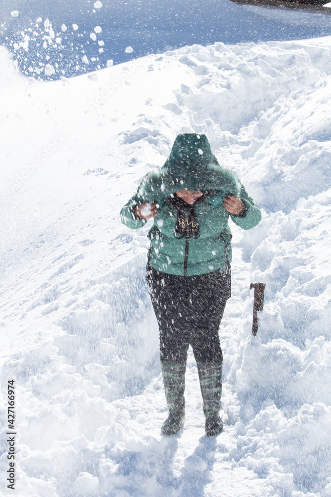 Woman wearing winter coat and enjoying snow powder Stock Photo | Adobe ...