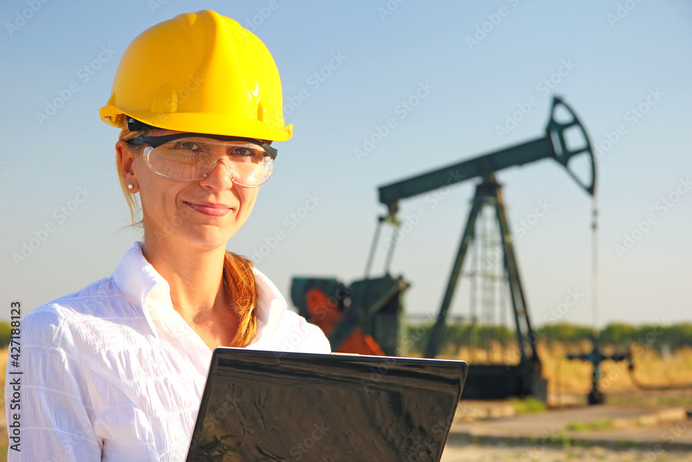 Successful female engineer with a notebook control the operation of the ...