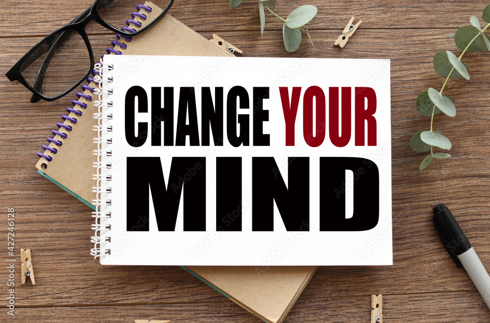 CHANGE YOUR MIND. text on white paper over torn paper background. Stock ...
