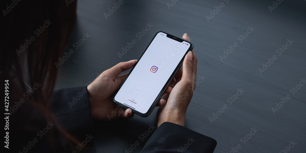 CHIANG MAI, THAILAND - APR 6 2021: Woman hand holding iphone with logo ...