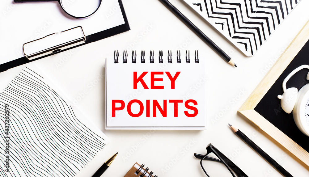 On a light table are notebooks, a magnifying glass, an alarm clock ...