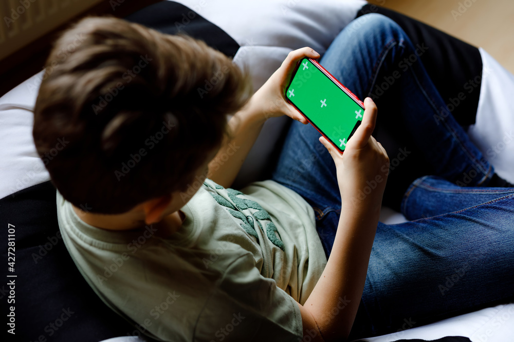 Kid boy gaming or using social media on mobile phone. chroma key ...