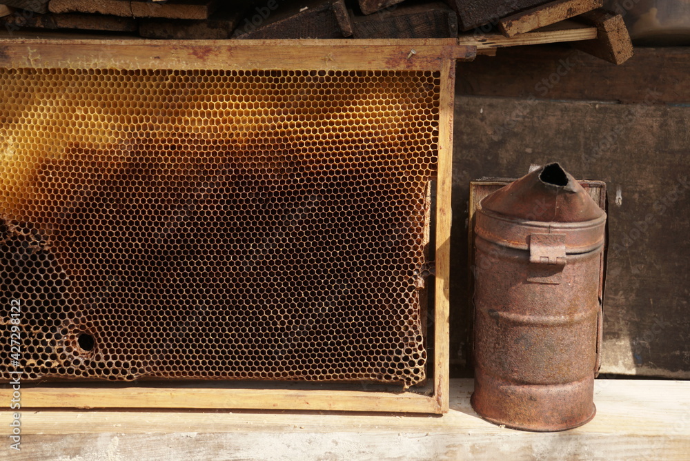 bee frame with honeycombs and smoke for bees Stock Photo | Adobe Stock