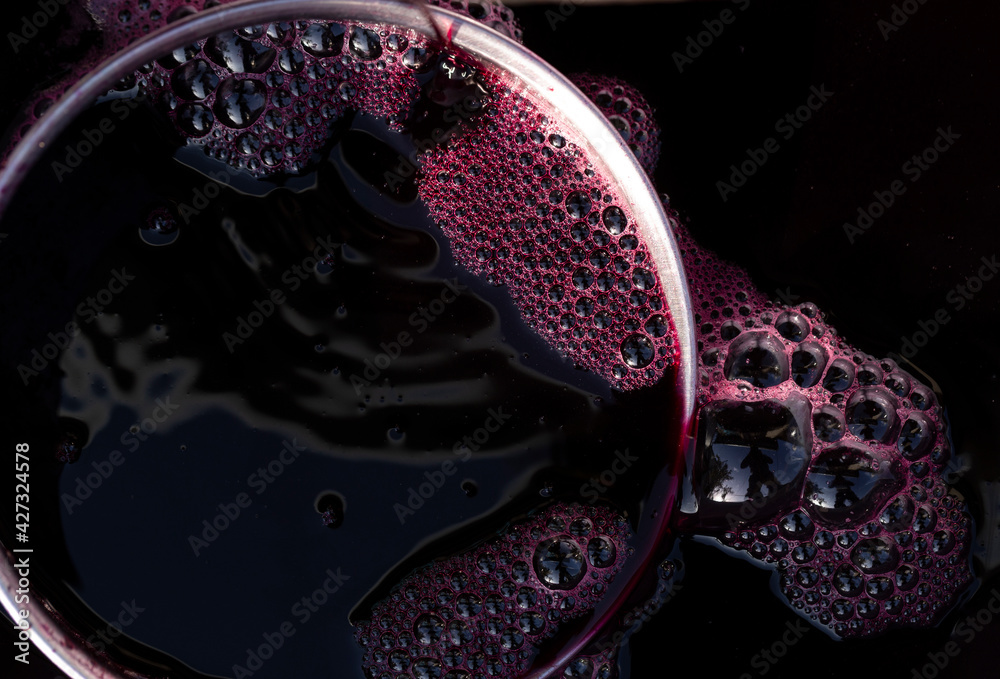 Wine making. Fresh grape juice with foam. Must flows and is collected ...