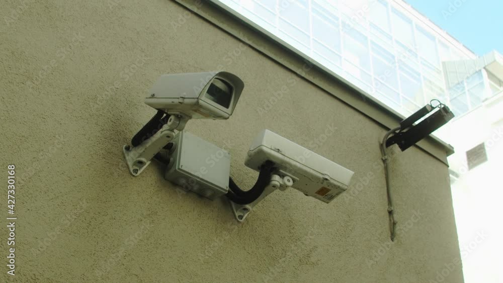 Security video camera moving to scan the area for surveillance purposes ...