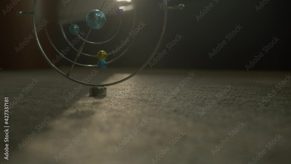 concentric rotating rings around a moving sphere. It looks like a ...