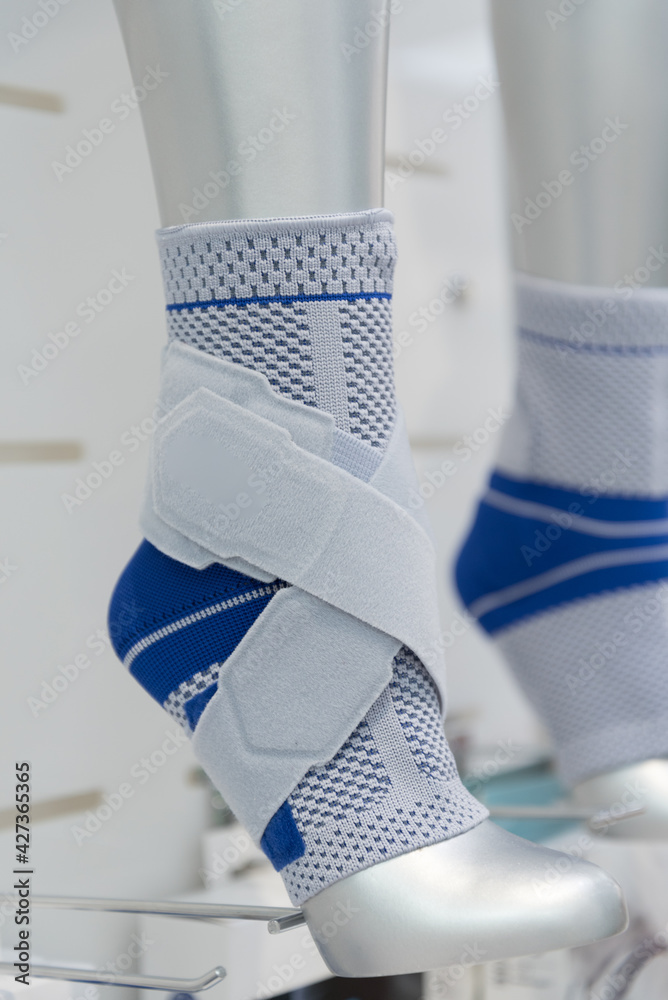 The showcase shows an ankle orthosis. A brace with straps is worn on ...