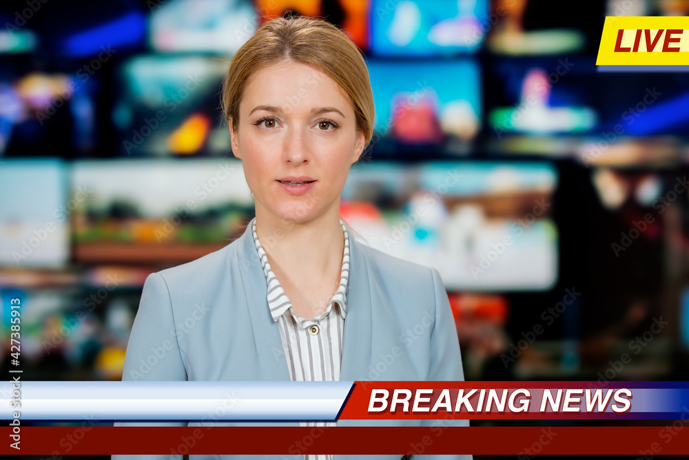 An anchorwoman reporting live breaking news sitting in Tv studio ...