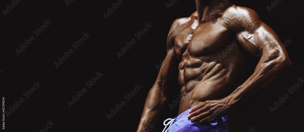 athlete bodybuilder in blue summer shorts at competitions in beach ...