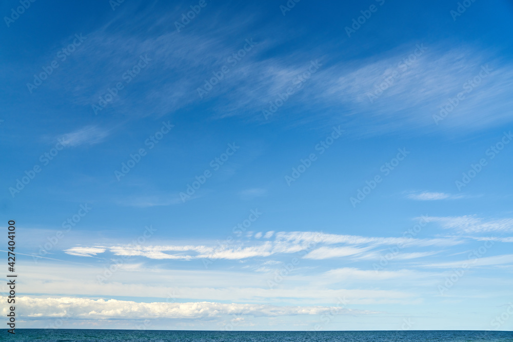 Blue sky with clouds over horizon of ocean Stock Photo | Adobe Stock