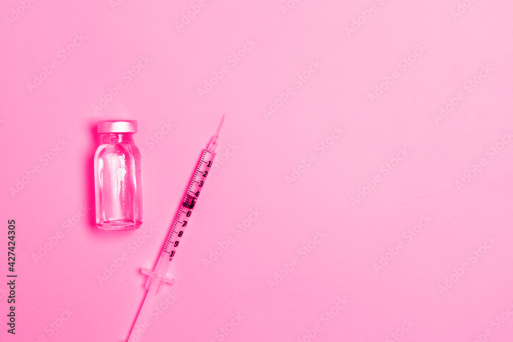 Syringe with medicine from glass vial on light pink background ...