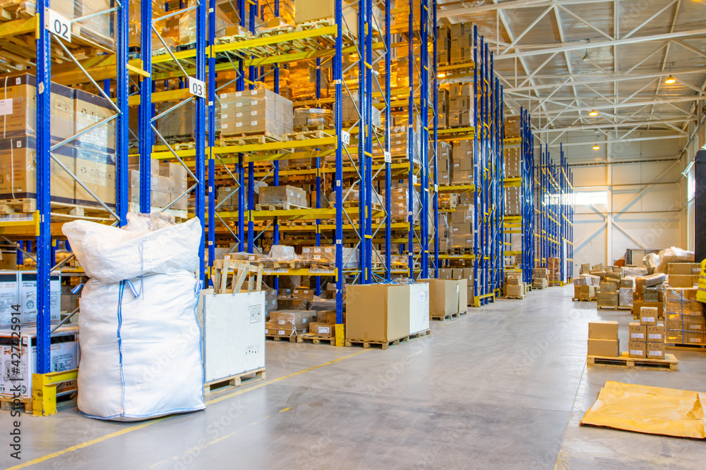 Interior of a modern warehouse storage with rows and goods boxes on ...