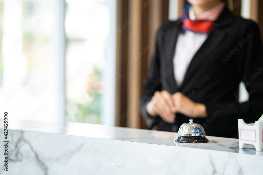 Close up bell in luxury modern reception hotel desk with the blurred ...