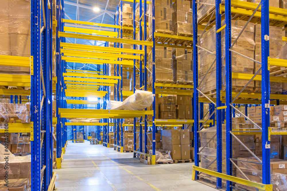 Interior of a modern warehouse storage with rows and goods boxes on ...