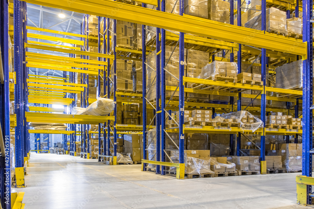 Interior of a modern warehouse storage with rows and goods boxes on ...