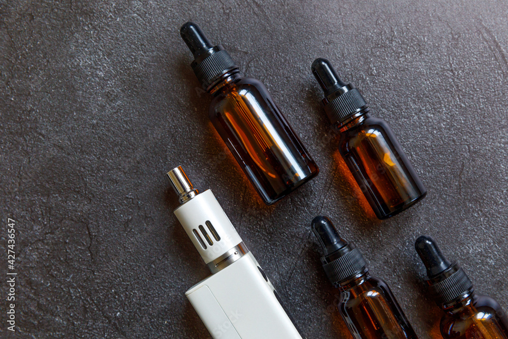 Vaping device e-cigarette electronic cigarette and liquid bottles on ...