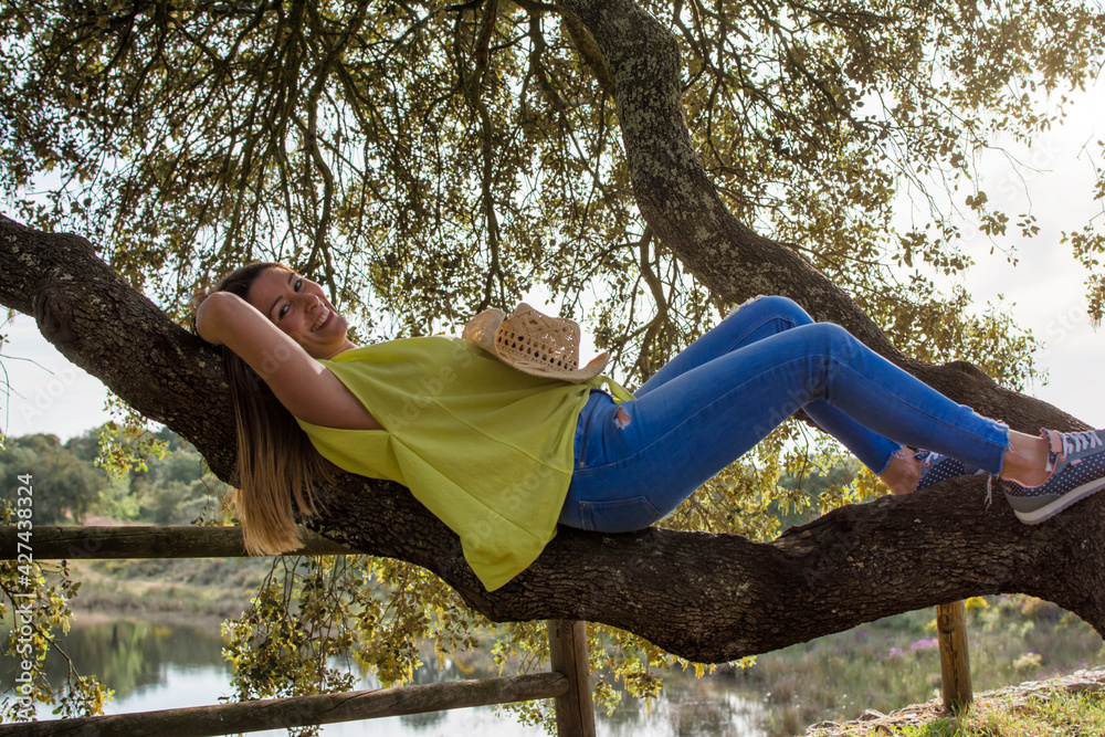 Beautiful Young Woman Enjoying A Nice Day In A Natural Park. She Is ...