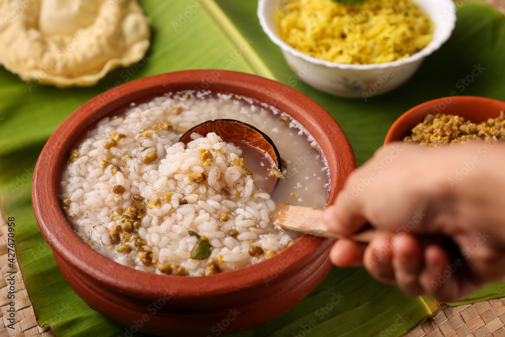 Rice porridge, Kanji, gruel in clay pot palm mat background Kerala ...