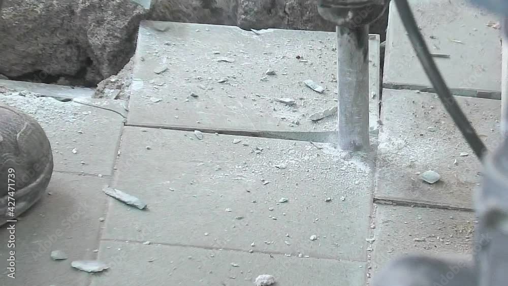 SLOW MOTION: workman using pneumatic drill in construction site and ...