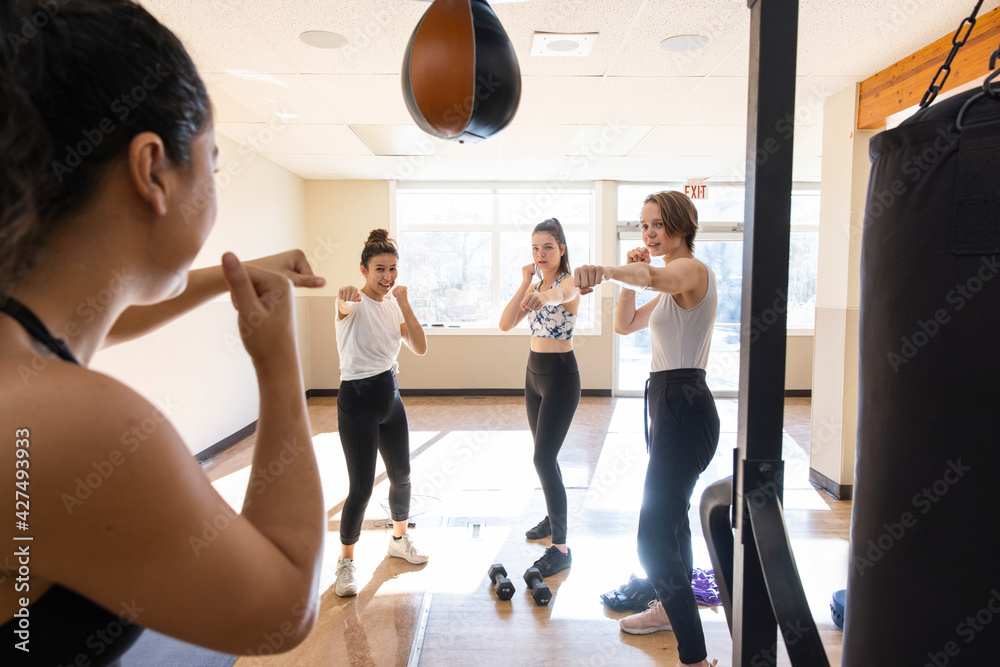 Teen girls practicing boxing fighting stance in gym studio Stock Photo ...