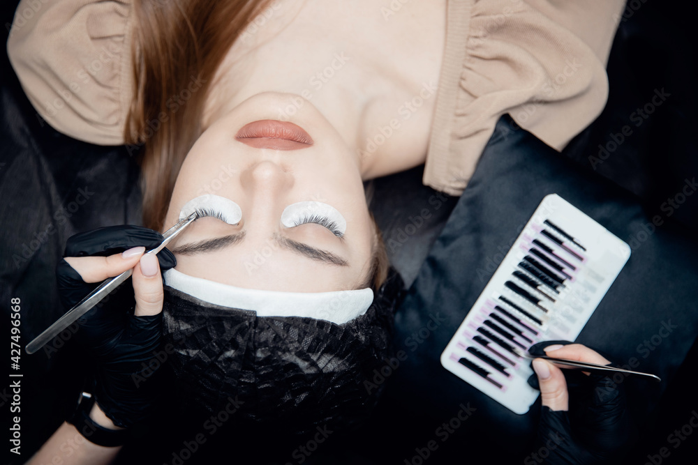 Eyelash extension procedure top view. Master tweezers fake 2d lashes ...