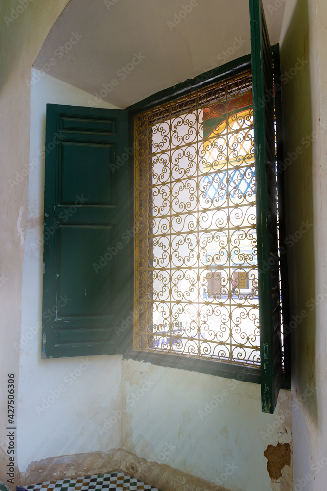 Open shutters on window. Streams of sunlight pass through lattice ...