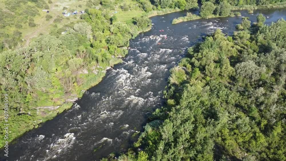 A fast stream of water carries a boat along the Southern Bug River ...
